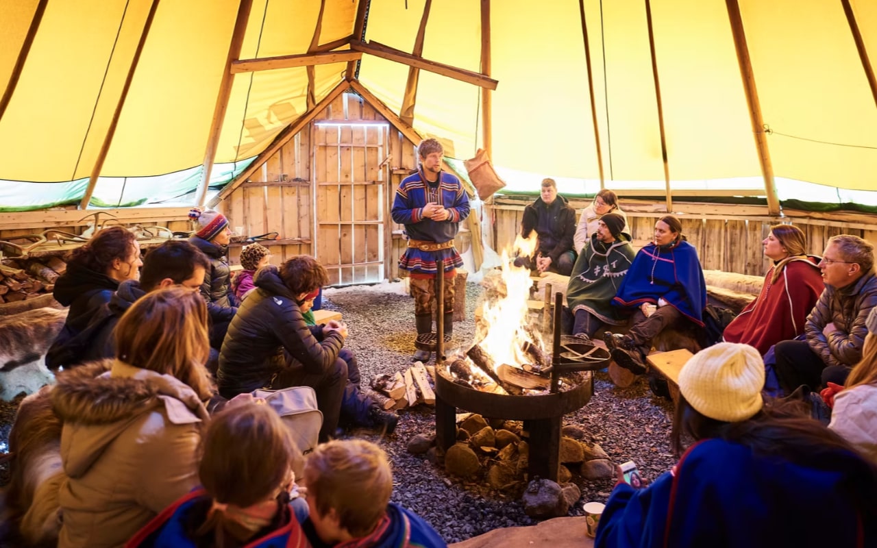 Listen to captivating Sami stories and ancient joik songs by the cozy fire