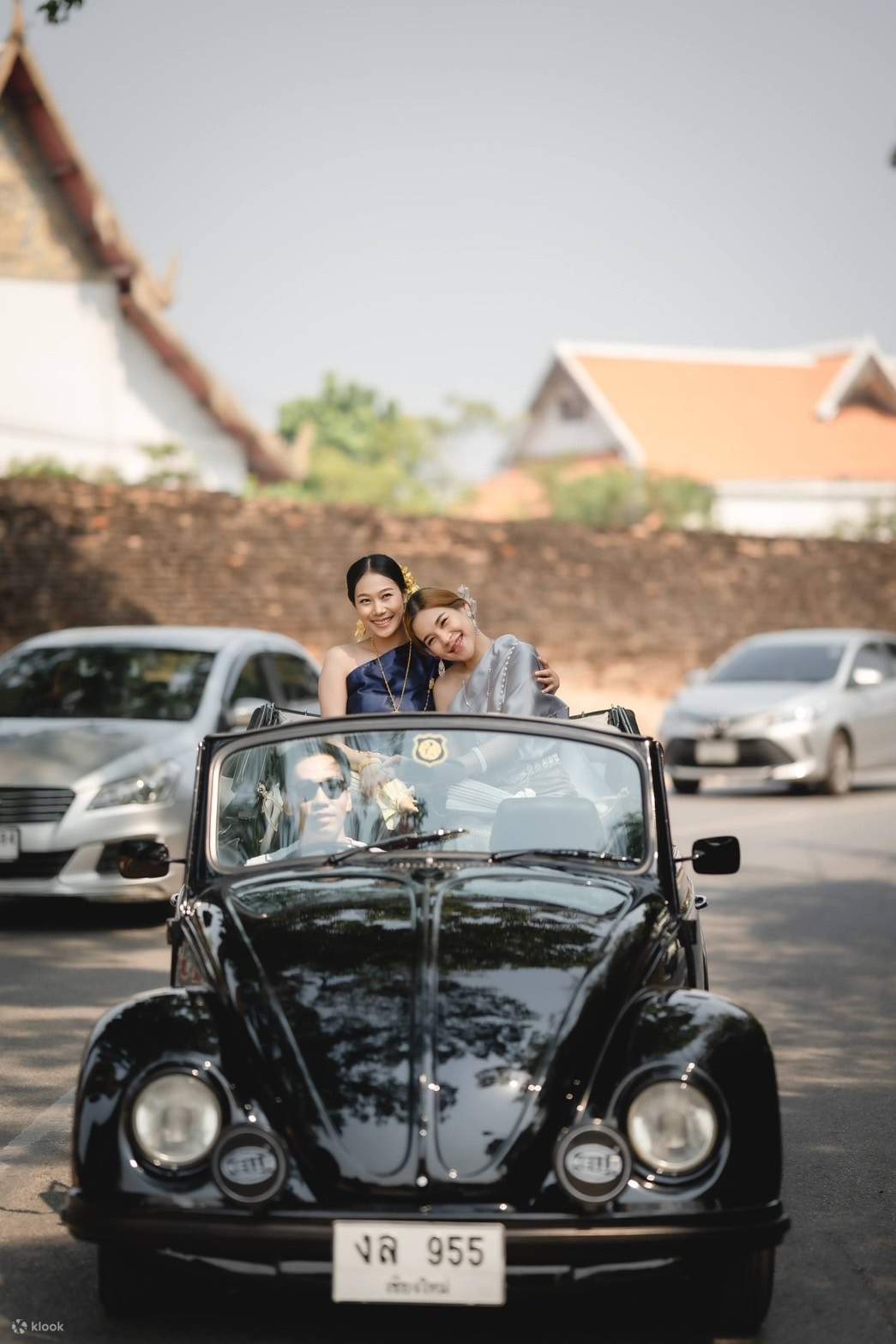 Thai dress rental with alongside a vintage cabriolet - Klook